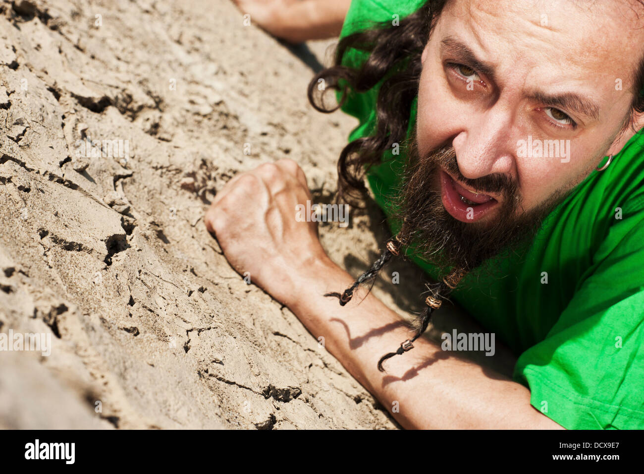 Man looking for water in parched soil Stock Photo - Alamy