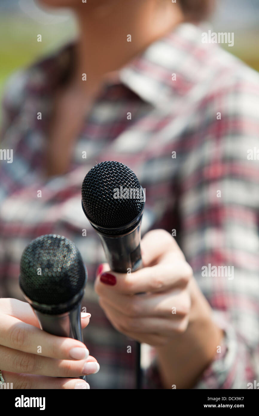 A journalist is making a interview with a microphone Stock Photo - Alamy