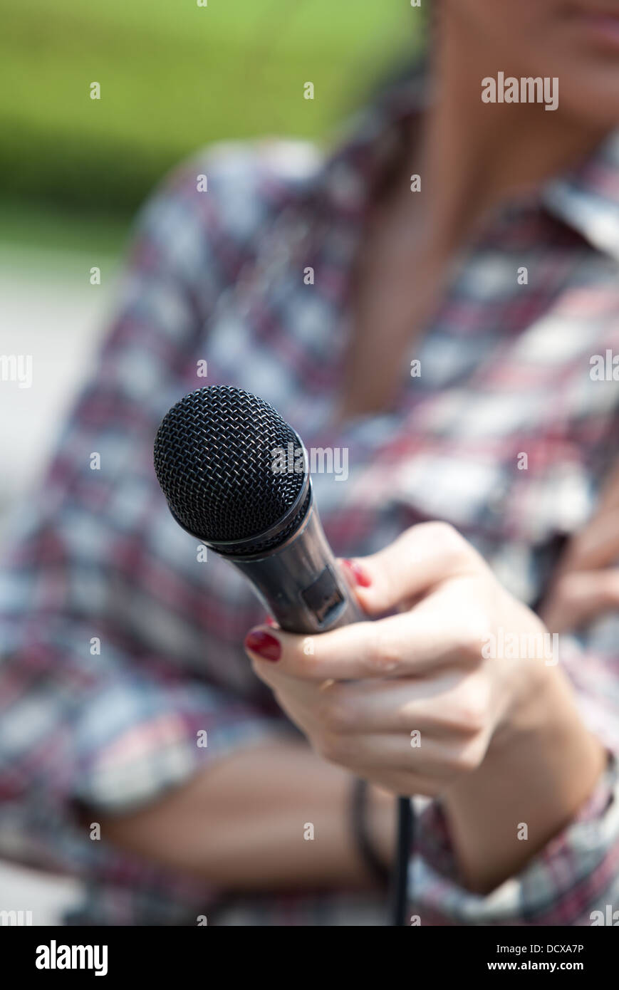 A journalist is making a interview with a microphone Stock Photo - Alamy