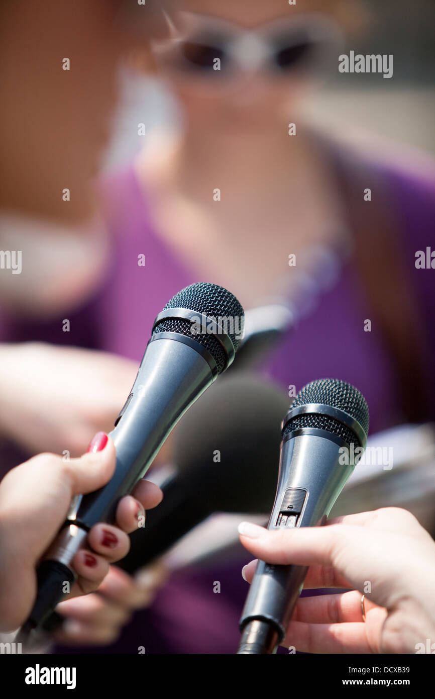 A journalist is making a interview with a microphone Stock Photo - Alamy