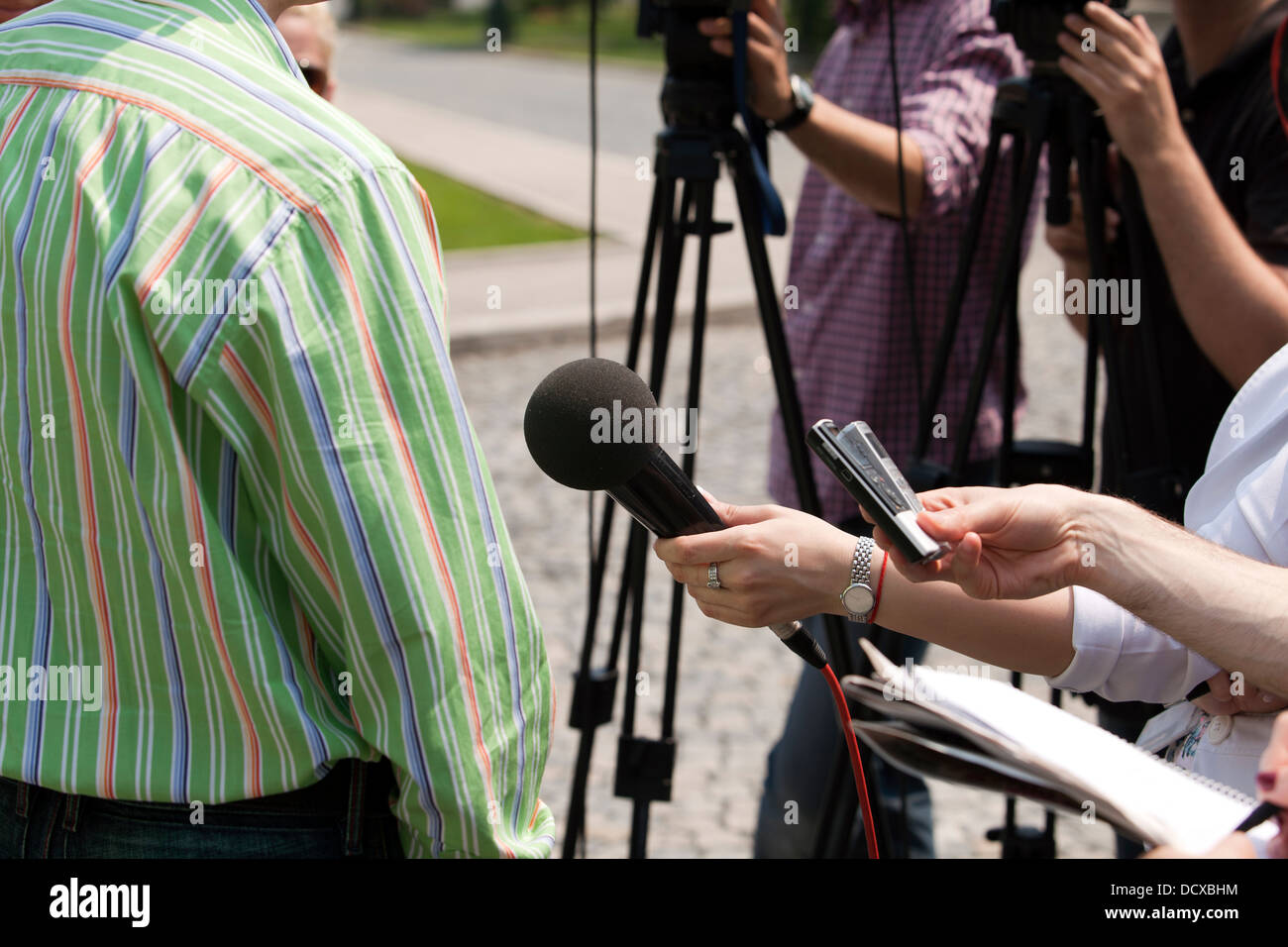 A journalist is making a interview with a microphone Stock Photo - Alamy