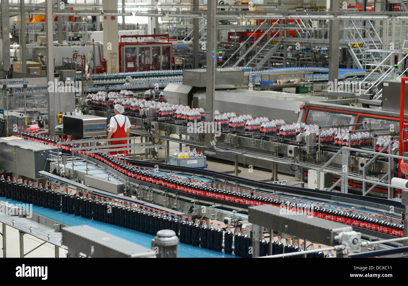 An employee is pictured next to the production line in the bottling ...