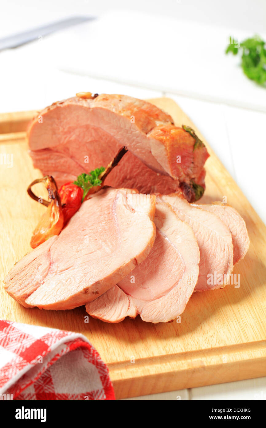 Slices of roasted pork on a cutting board Stock Photo - Alamy