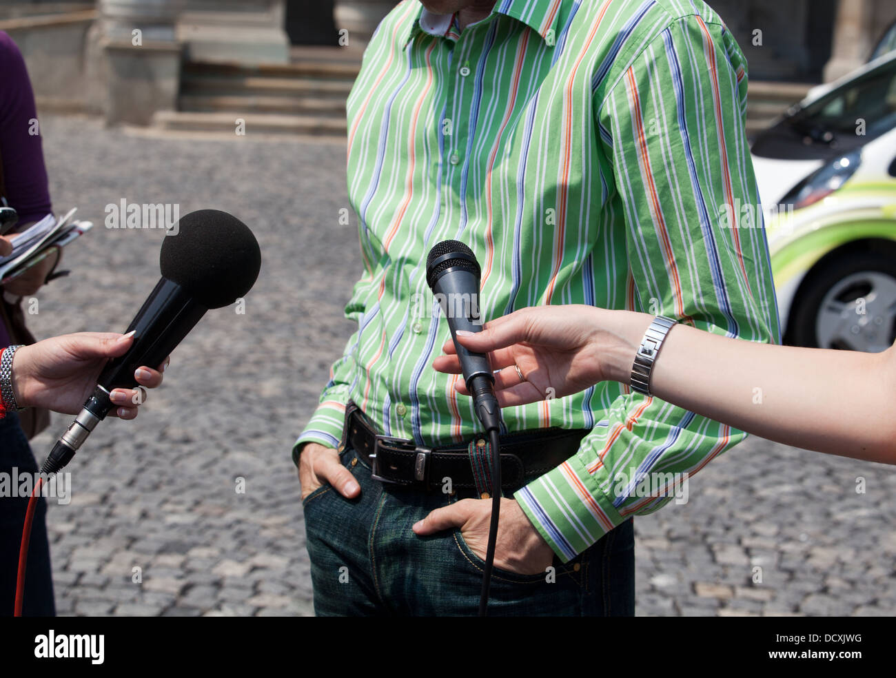 A journalist is making a interview with a microphone Stock Photo - Alamy