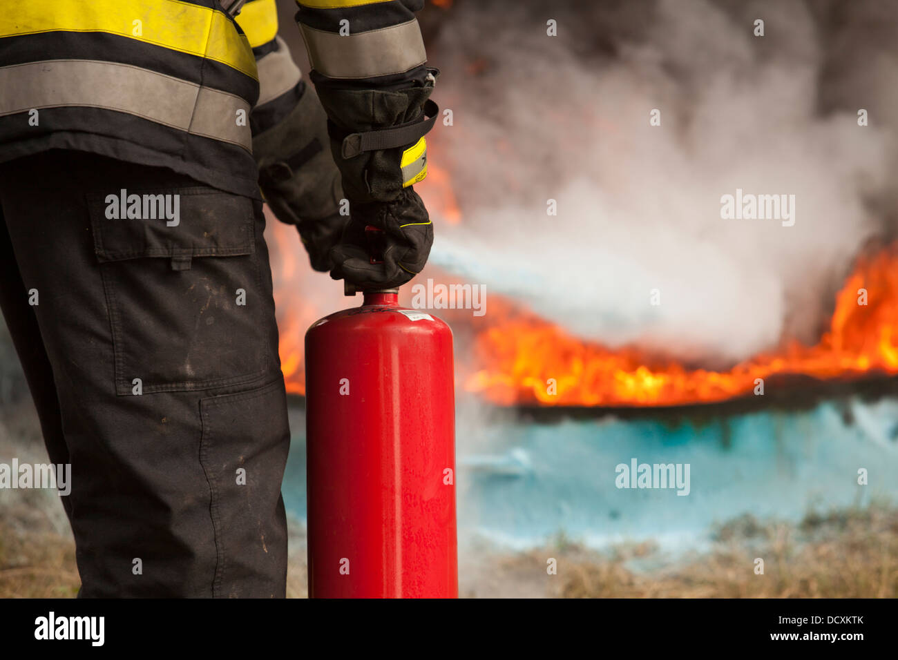 firefighter fighting fire Stock Photo - Alamy
