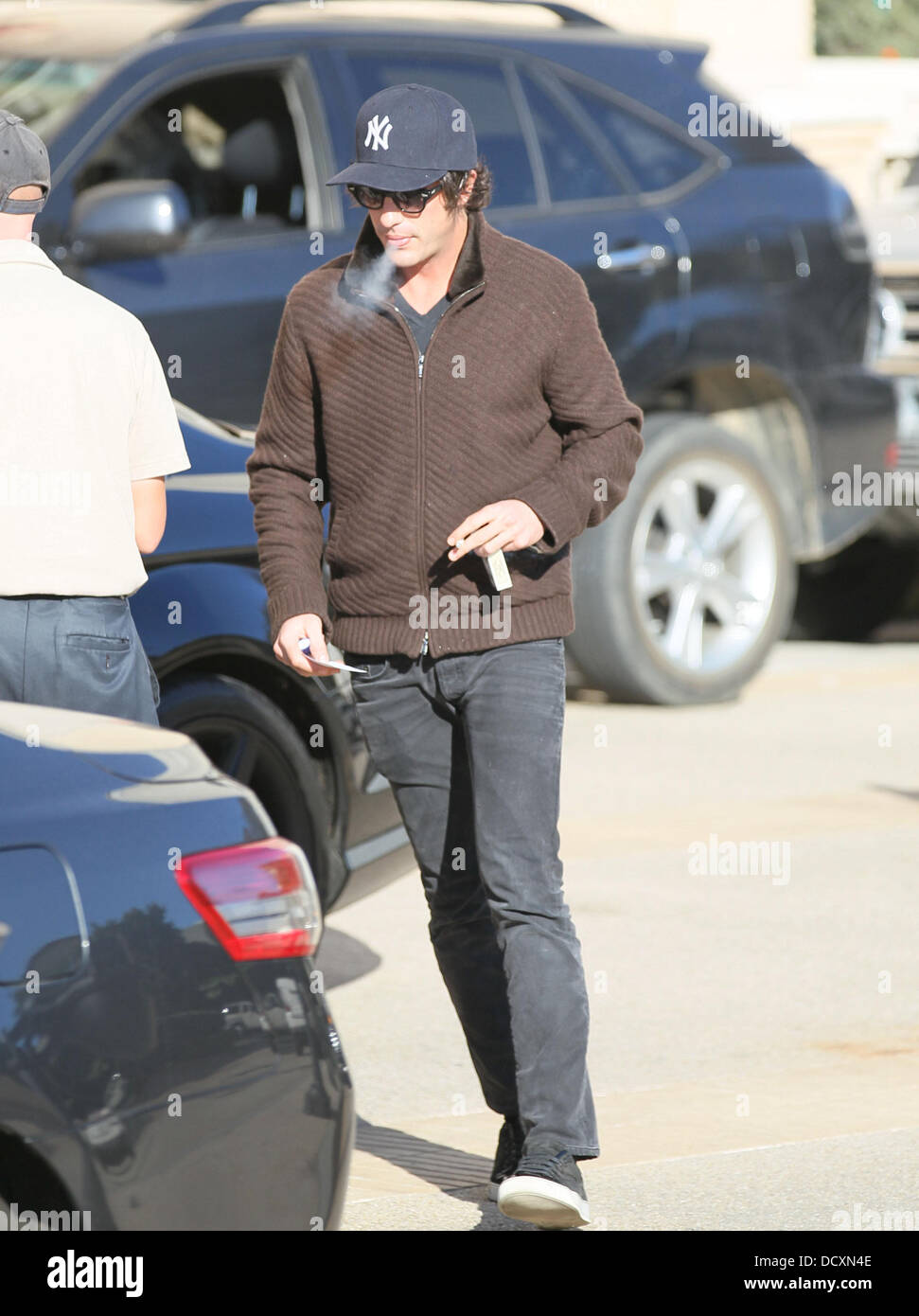 Brandon Davis smoking a cigarette as he shops at Barney's of New York ...