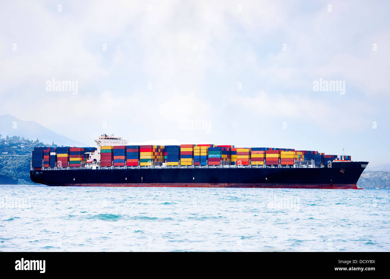 Large cargo ship in water carrying colorful shipping containers Stock ...