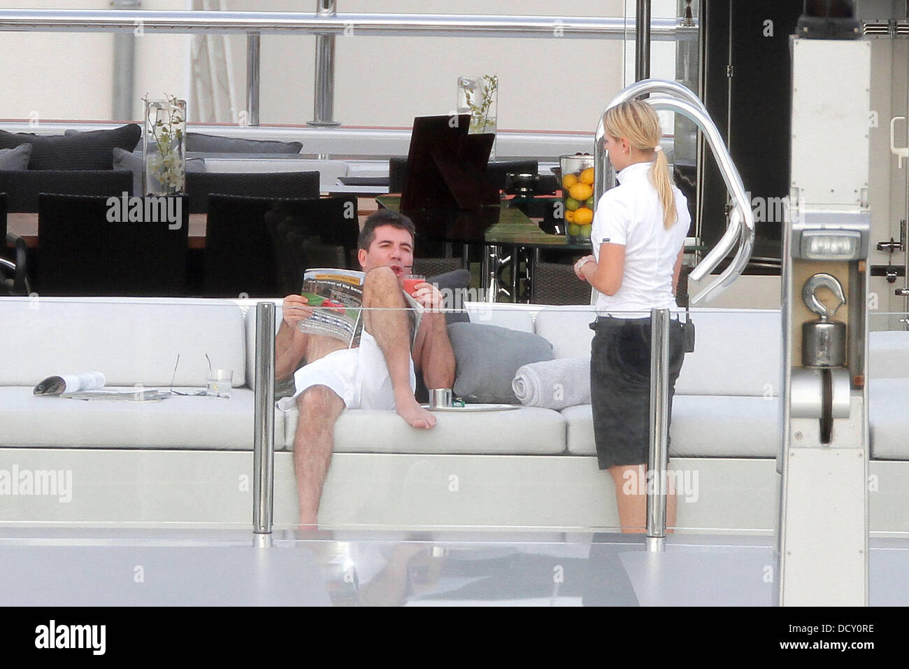 Simon Cowell orders a drink as he relaxes onboard the luxury super ...