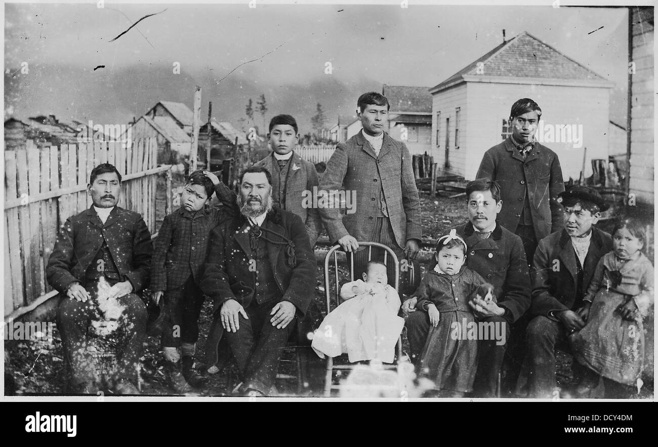 This image depicts an Indian family, capturing a moment of traditional ...