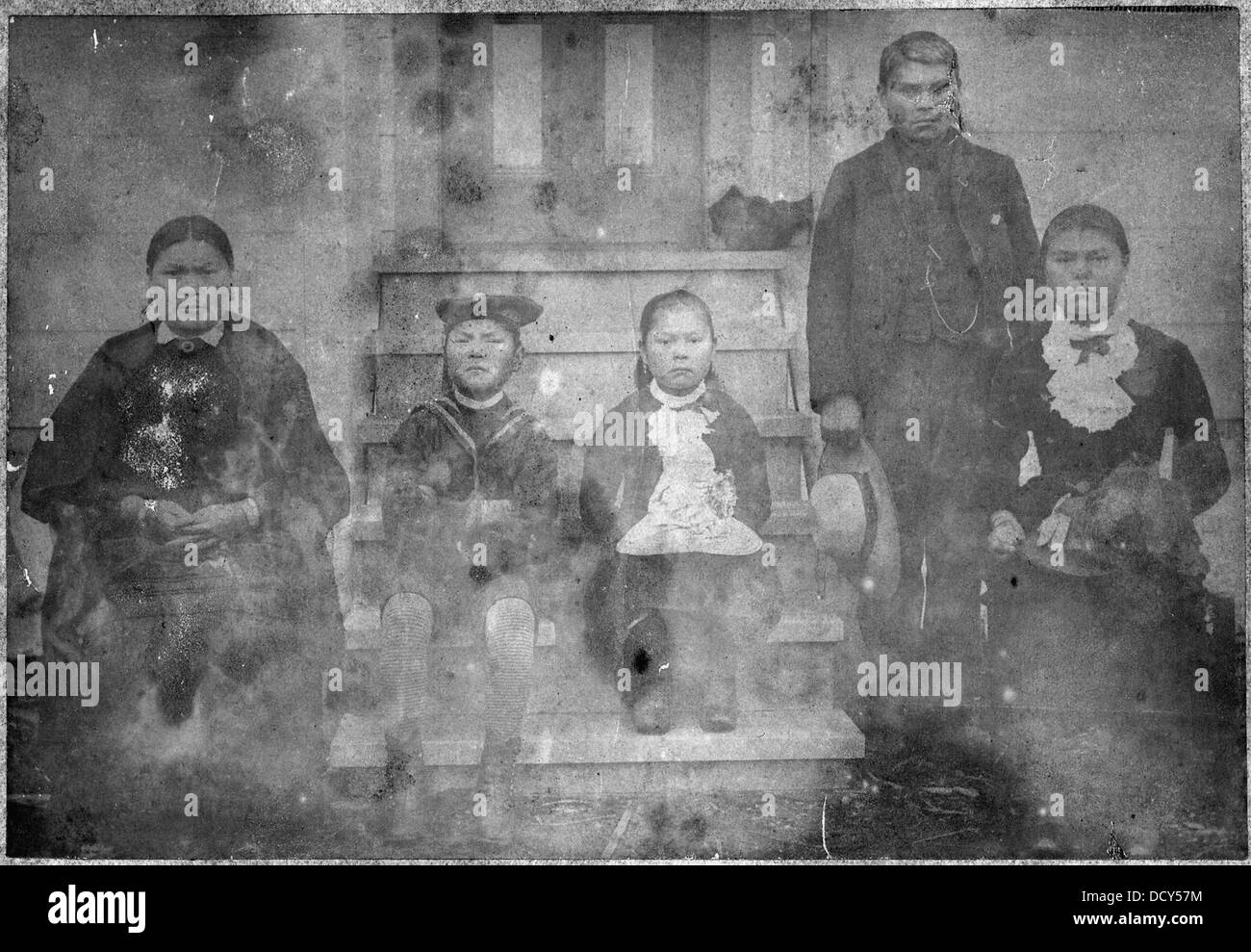This image depicts a traditional Native American family, emphasizing ...