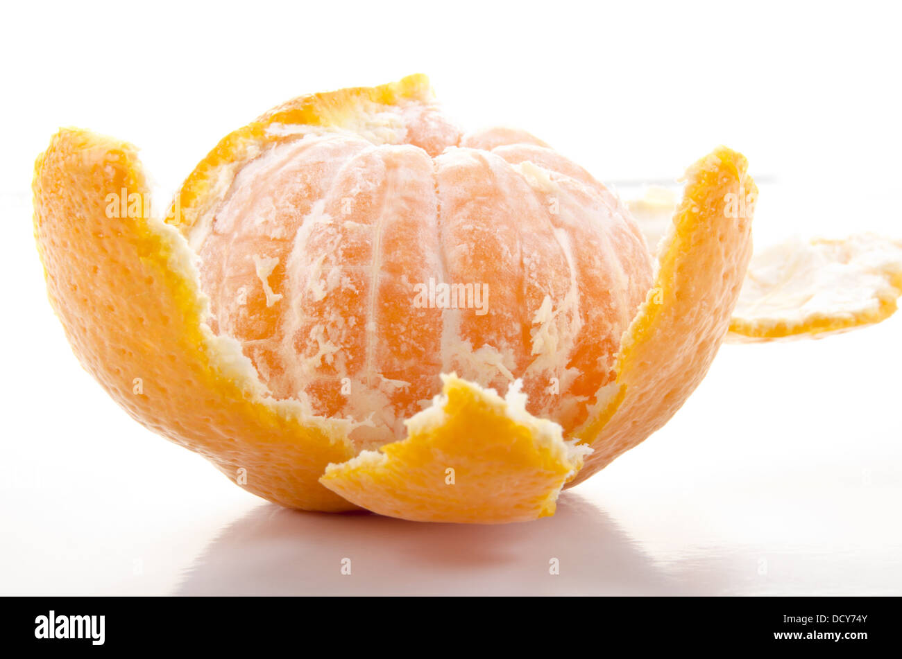one open organic mandarin on white background Stock Photo - Alamy