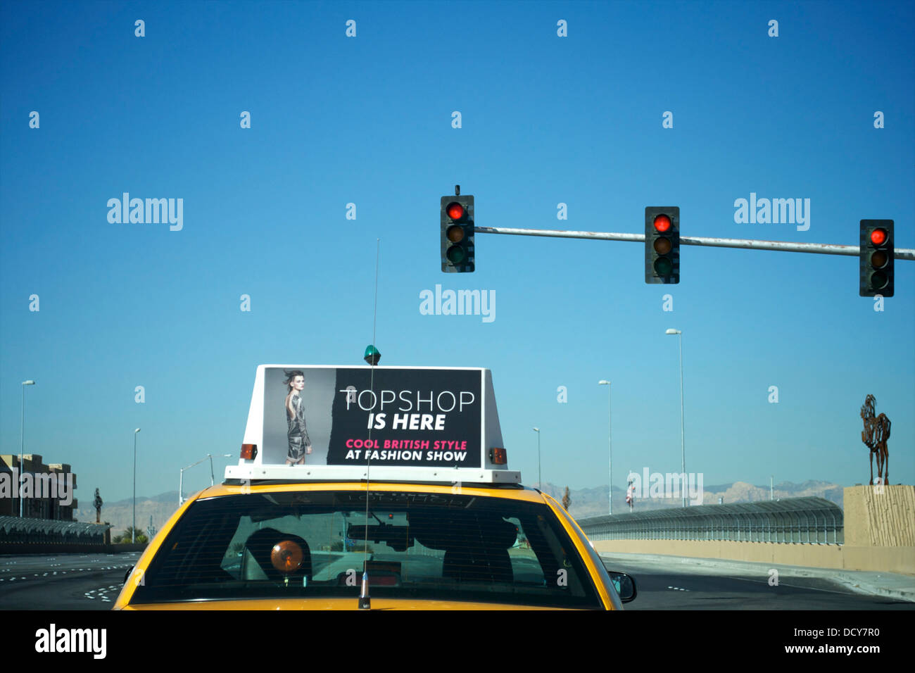 Taxi cab on a highway in Nevada, stopped at red traffic lights with ...