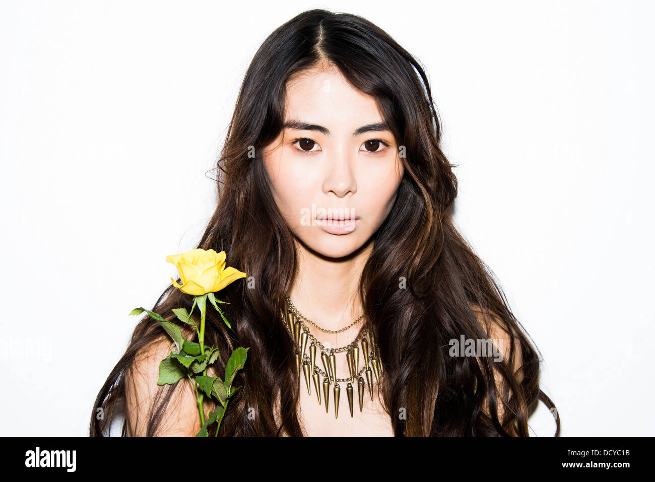 Young Woman Holding Yellow Rose Stock Photo - Alamy