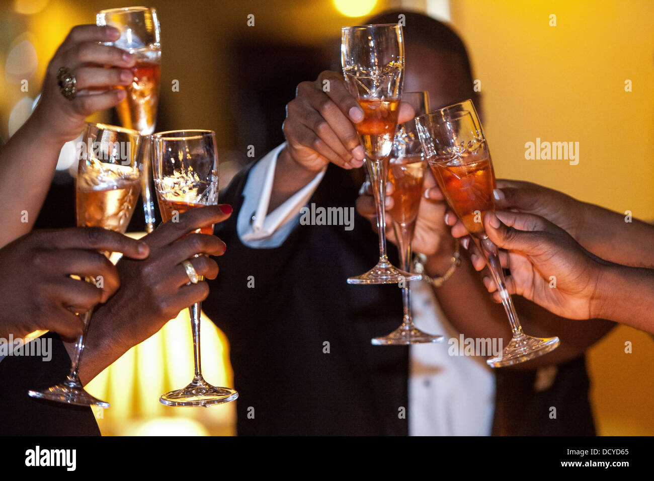 Champagne glasses being raised close-up Stock Photo - Alamy