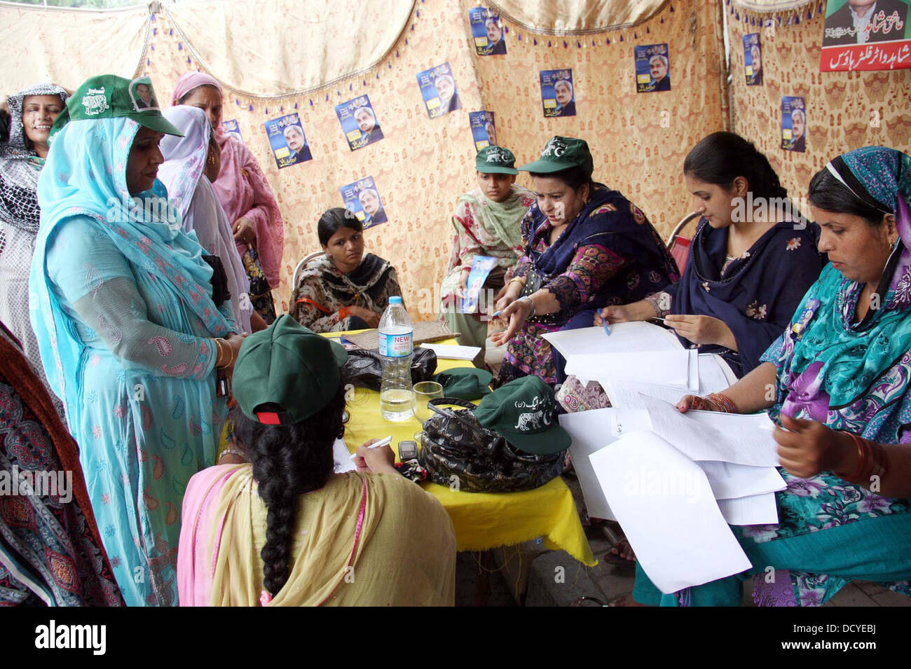 Voters check their names in voter list for casting their votes outside ...