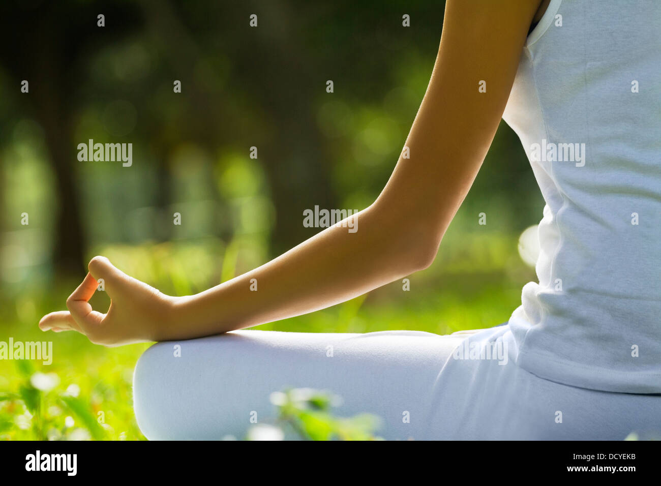 Young woman sitting in lotus position Stock Photo - Alamy