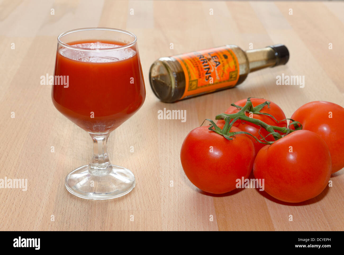A refreshing glass of tomato juice pictured with tomatoes on the vine ...