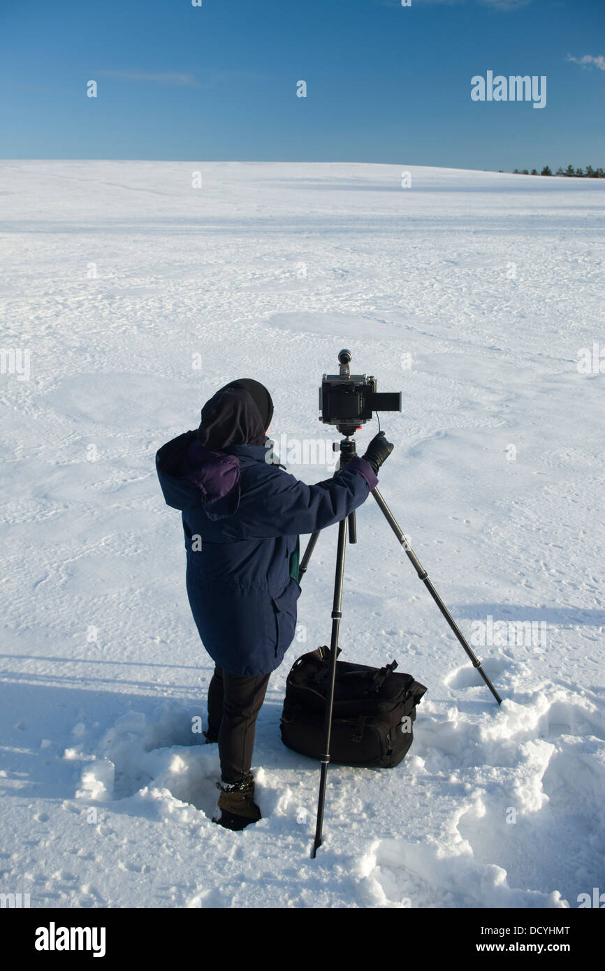 FEMALE PHOTOGRAPHER IN SNOW COVERED LANDSCAPE Stock Photo - Alamy