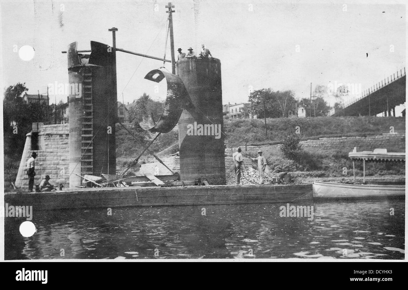 A photo showing the first steel ring being lowered from tubes during ...