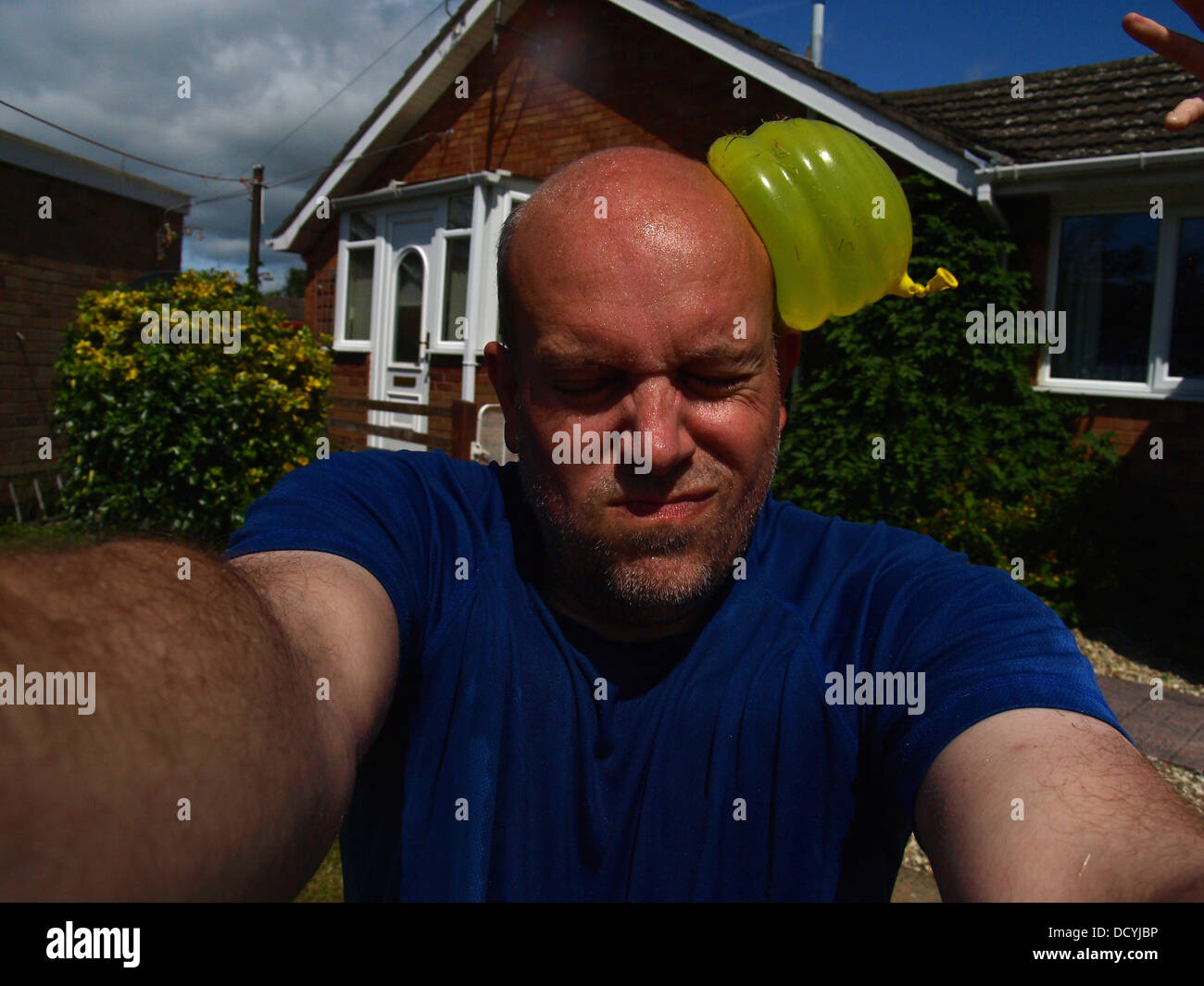 Man getting hit by water balloon Stock Photo - Alamy