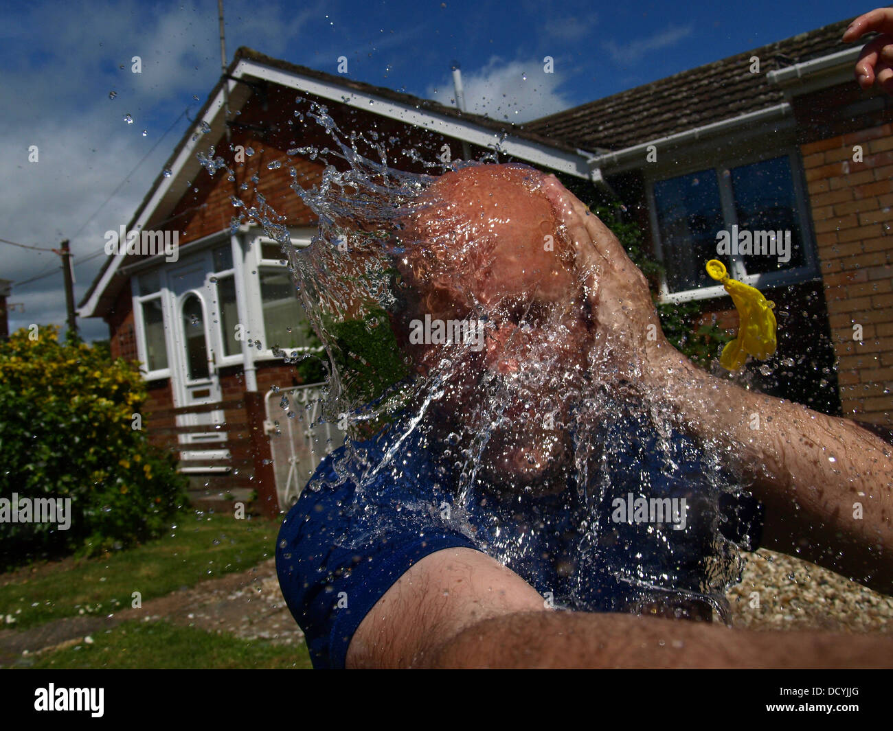 Man getting hit by water balloon Stock Photo - Alamy