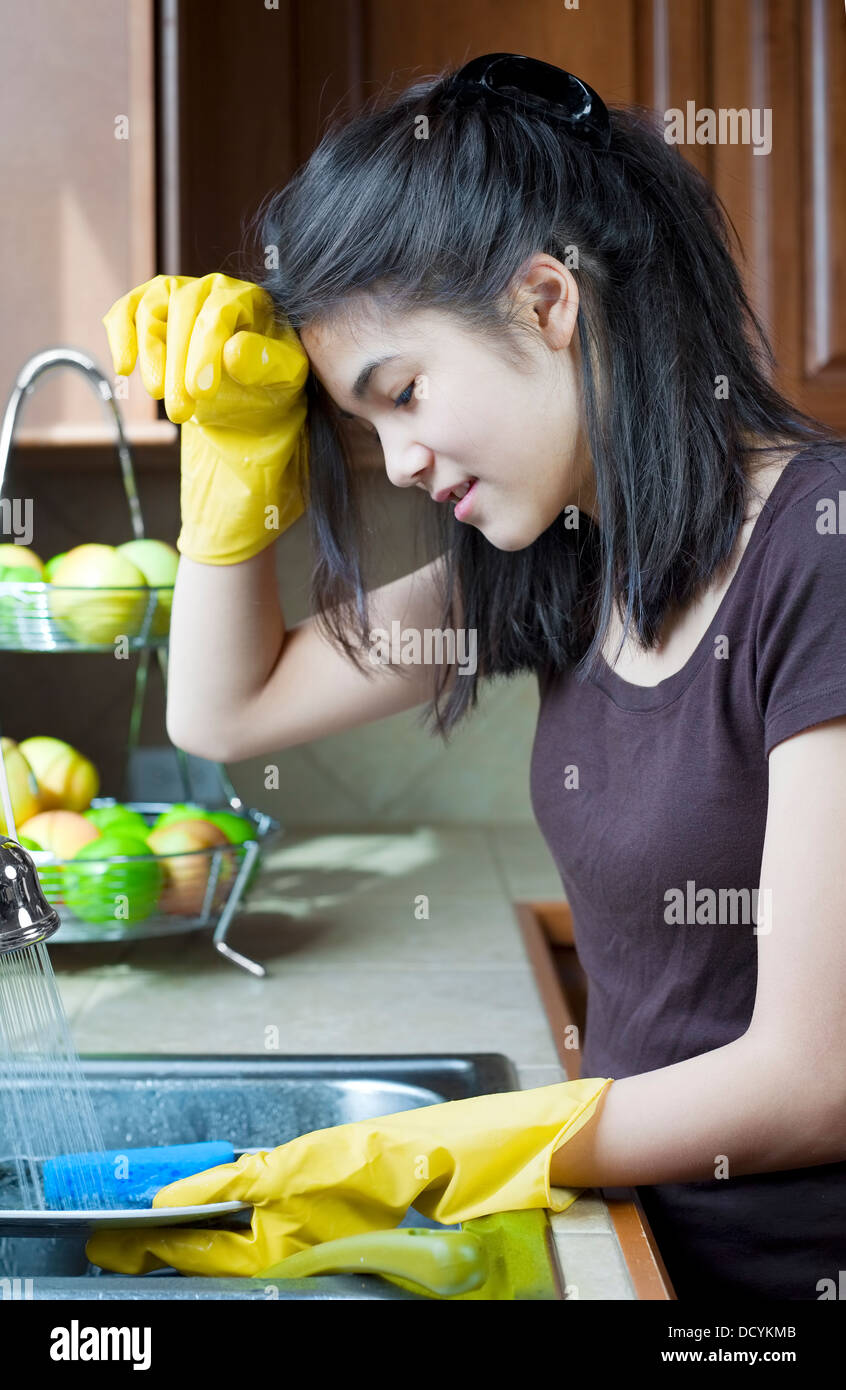 Teen girl washing dishes hi-res stock photography and images - Alamy