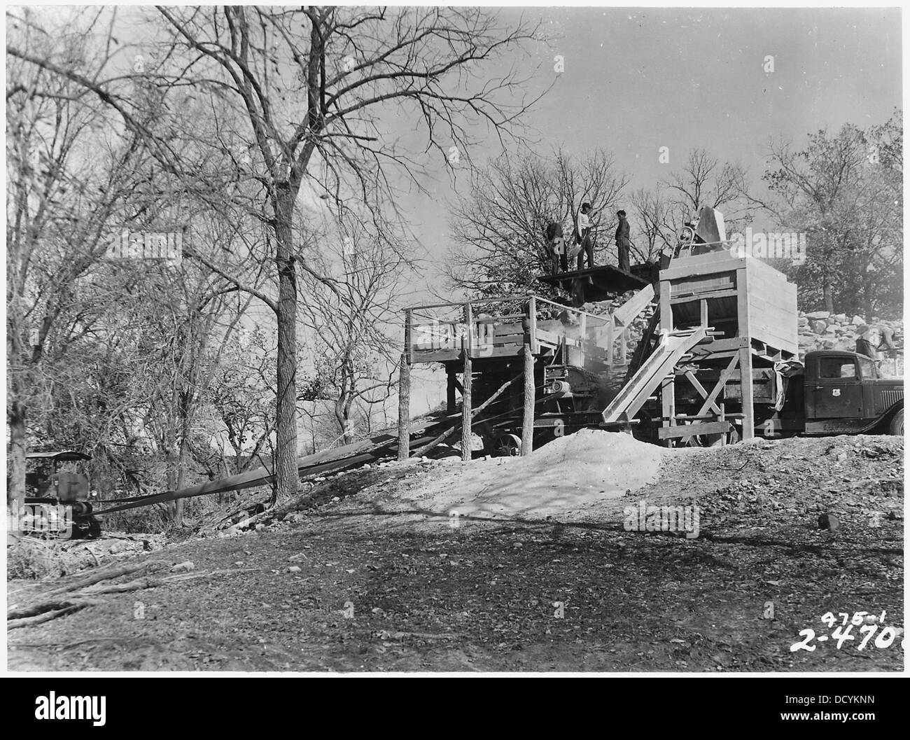 Men are shown working in a limestone quarry, crushing and pulverizing ...