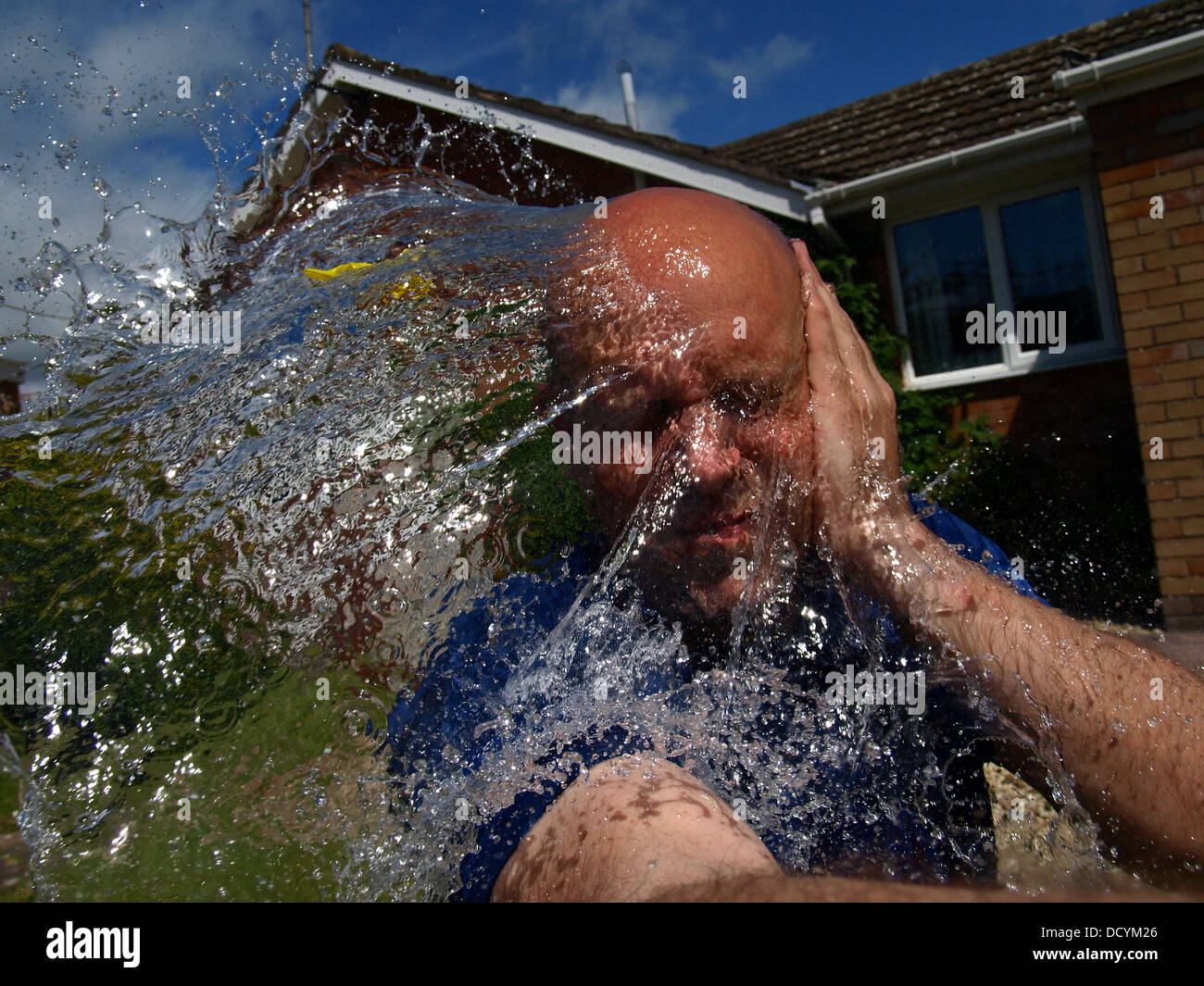 Man getting hit by water balloon Stock Photo - Alamy