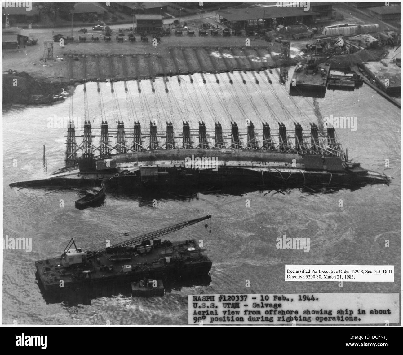 An aerial view of the USS Utah in a salvaged position after its sinking ...