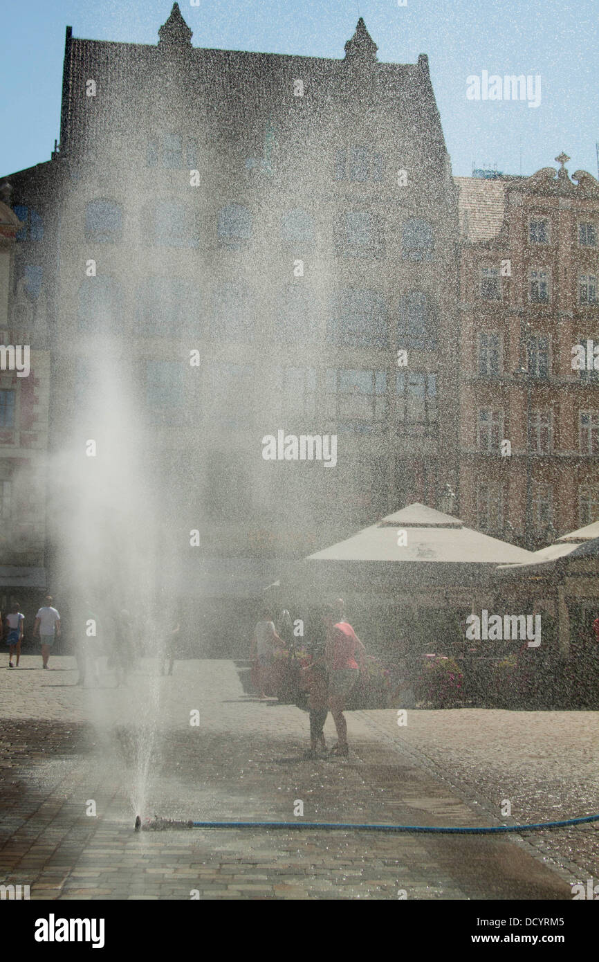 Water spray in city center during hot summer day Stock Photo - Alamy
