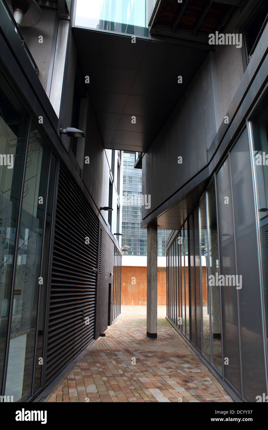 A passageway between two modern buildings with dark contrasts Stock ...