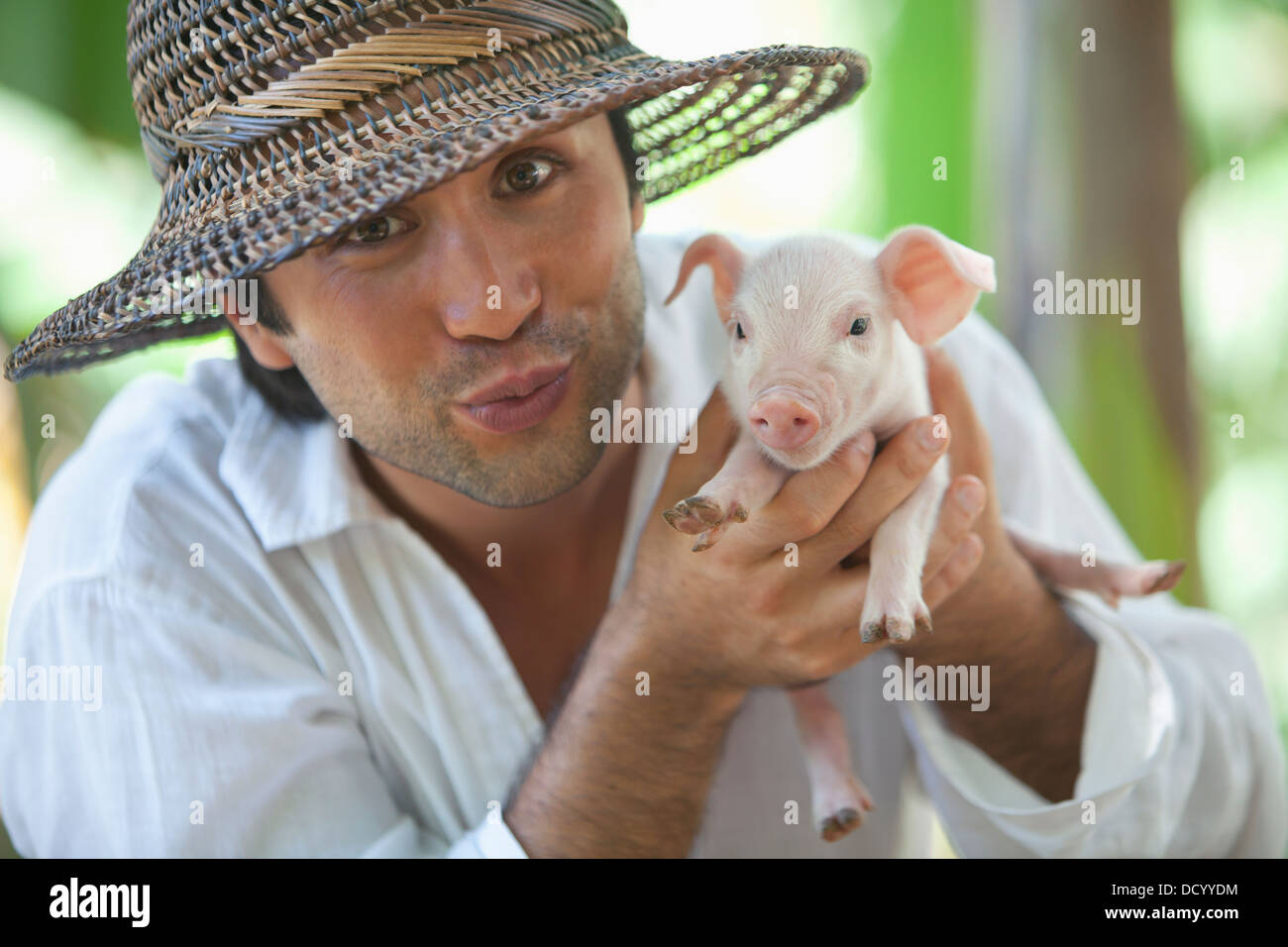 A Man Holds A Baby Pig; Island Of Bohol, Philippines Stock Photo - Alamy