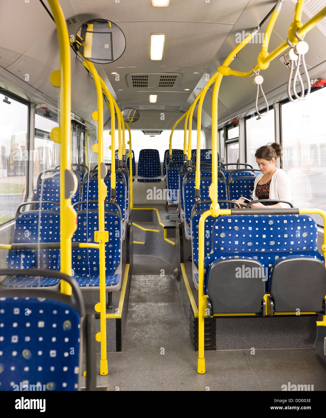 Reading on the bus Stock Photo - Alamy