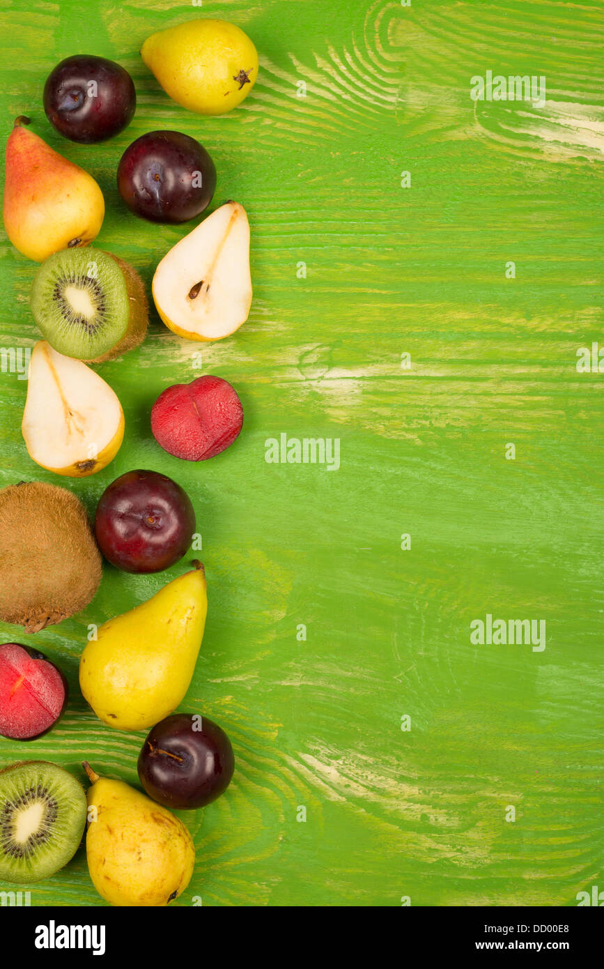 Fresh fruit arranged on a rustic background Stock Photo - Alamy