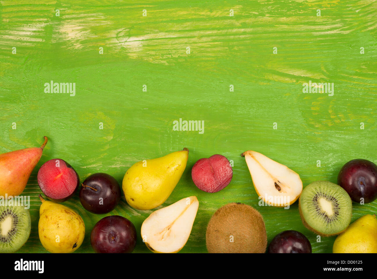 Assortment of different fruit arranged on a rustic wooden background ...