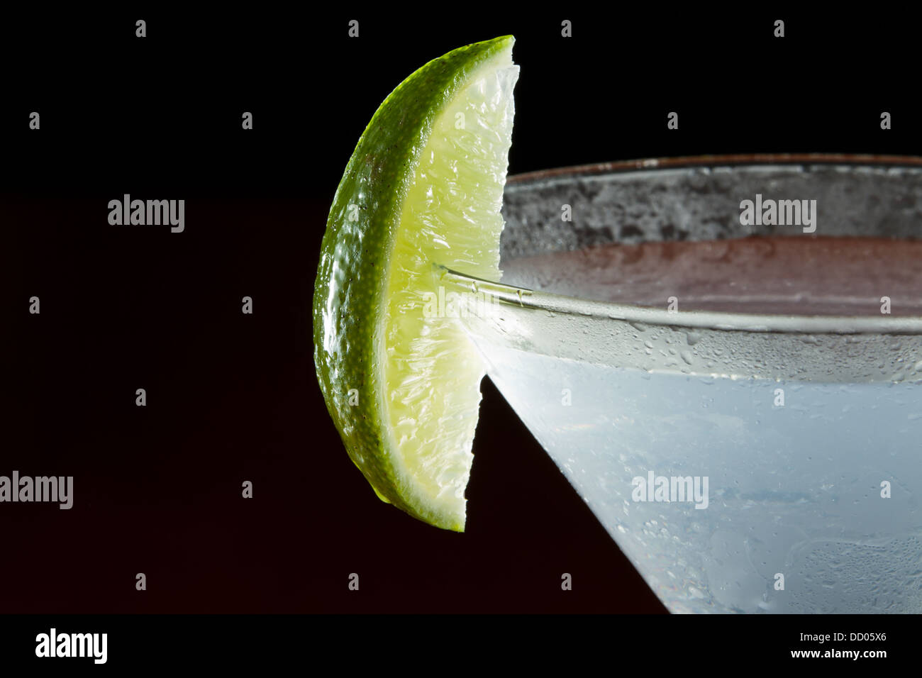 lime wedge on the rim of a martini glass used as a garnish isolated on ...