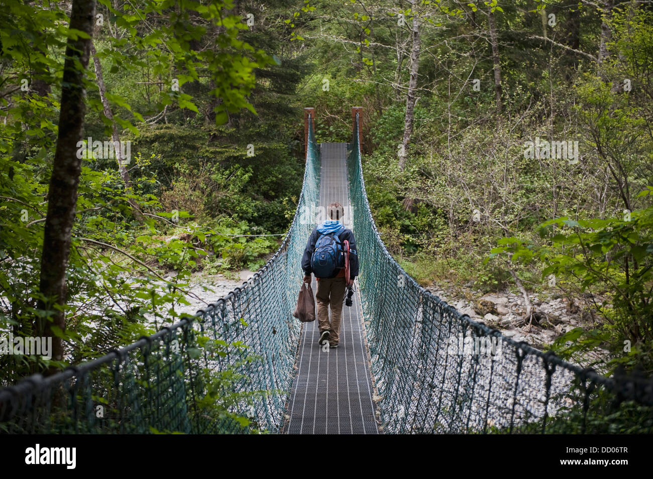 A Person Walking Over A Suspension Bridge In China Beach; British ...