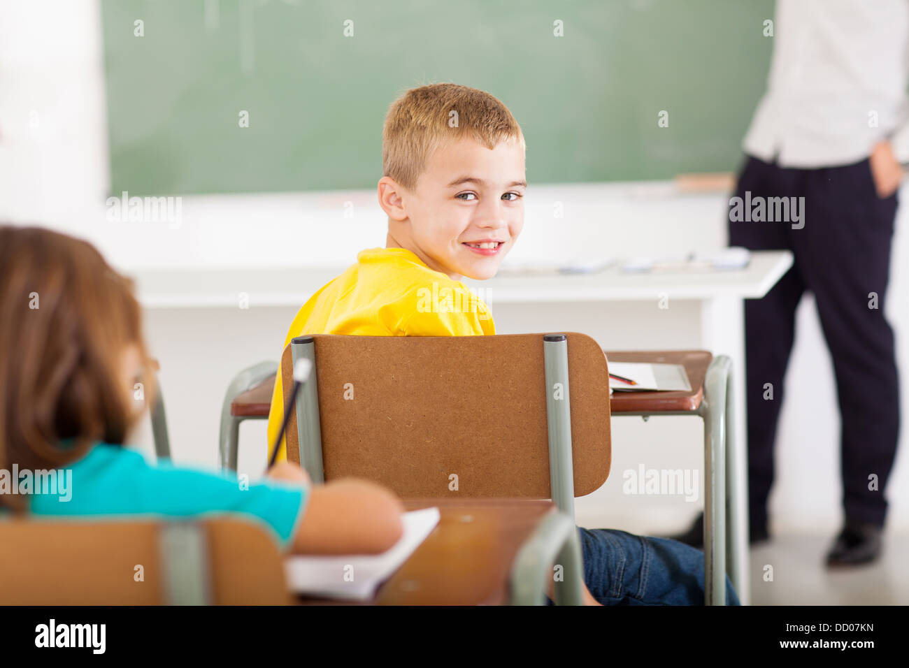 cute primary school student looking back in classroom Stock Photo - Alamy
