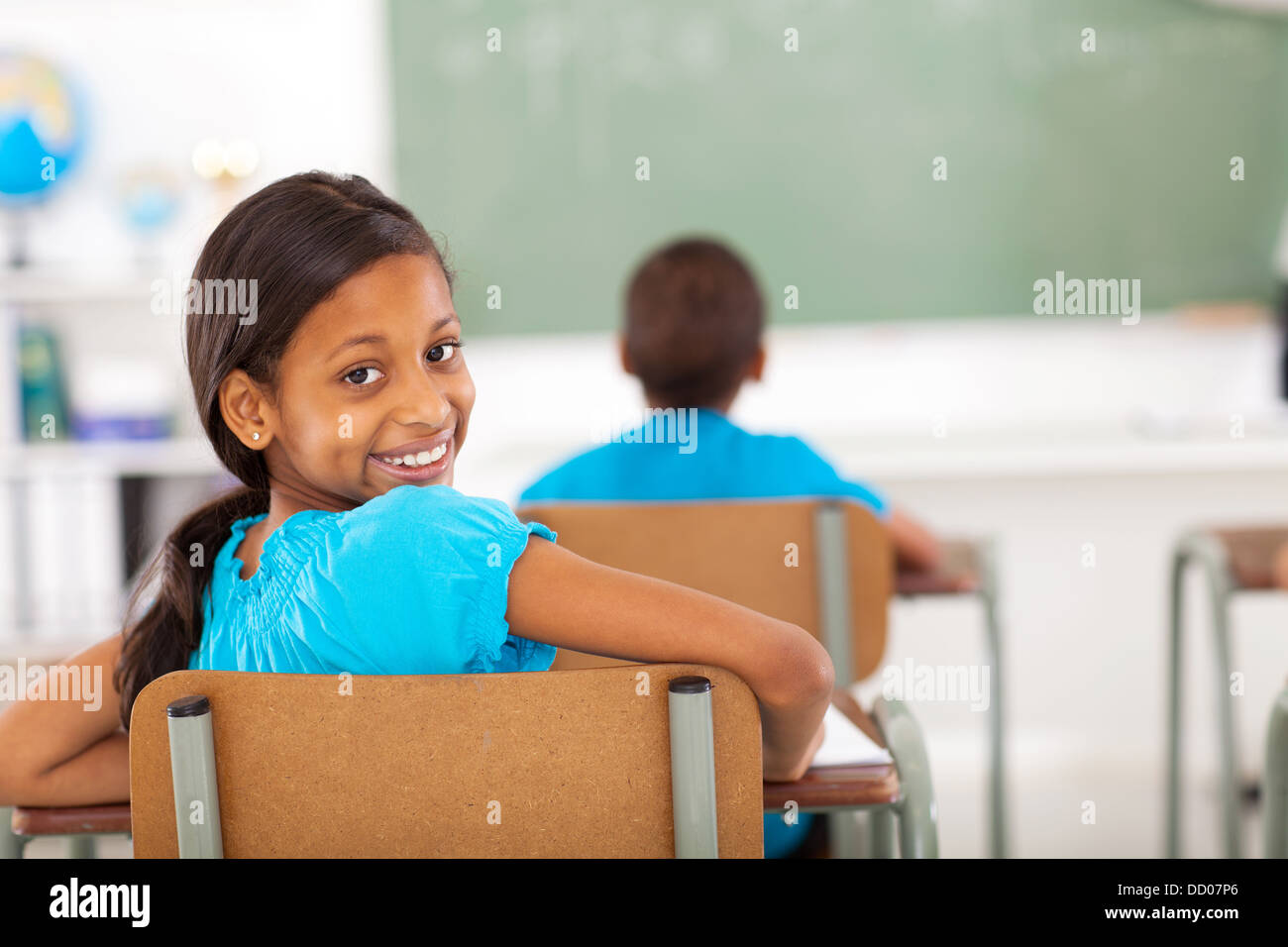 cute primary school girl in classroom looking back Stock Photo - Alamy
