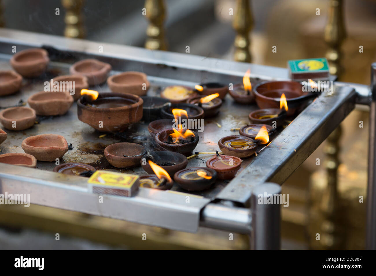 Oil lamps in hindu temple hi-res stock photography and images - Alamy