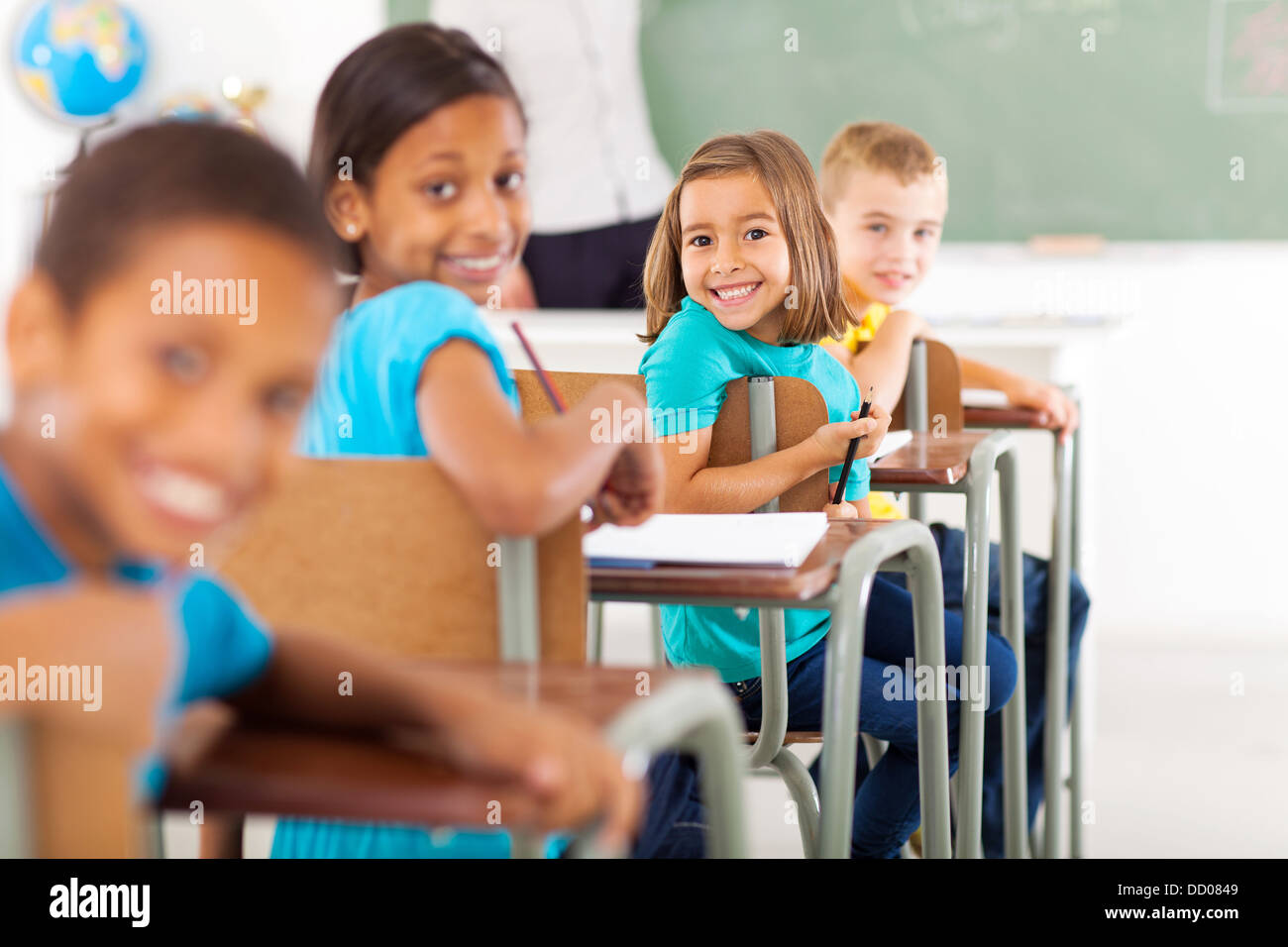 group of primary school students in classroom looking back Stock Photo ...