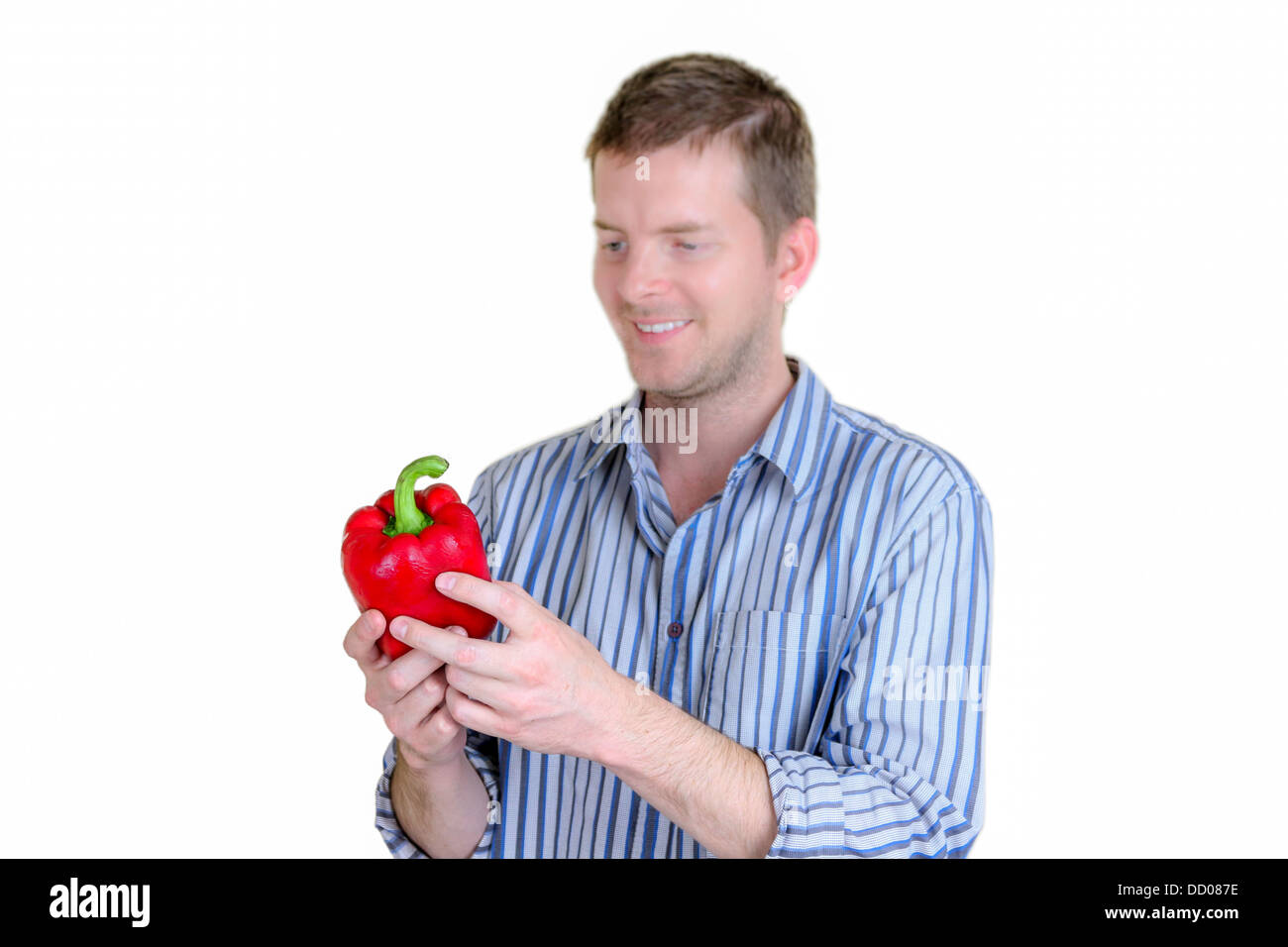 Man holding a big red bell pepper Stock Photo - Alamy