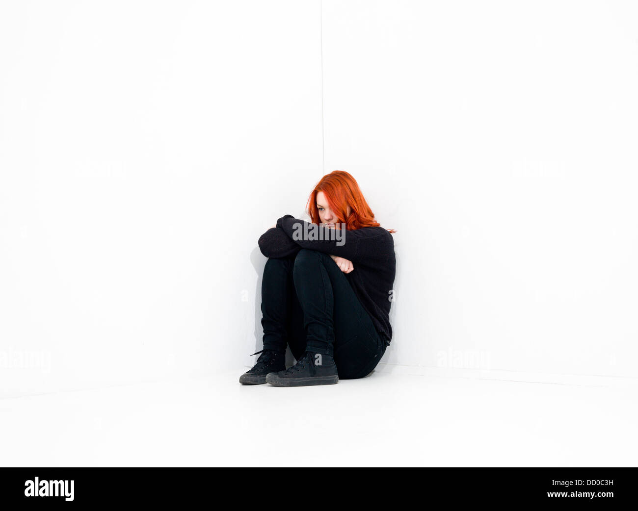 Sad woman standing wall Cut Out Stock Images & Pictures - Alamy