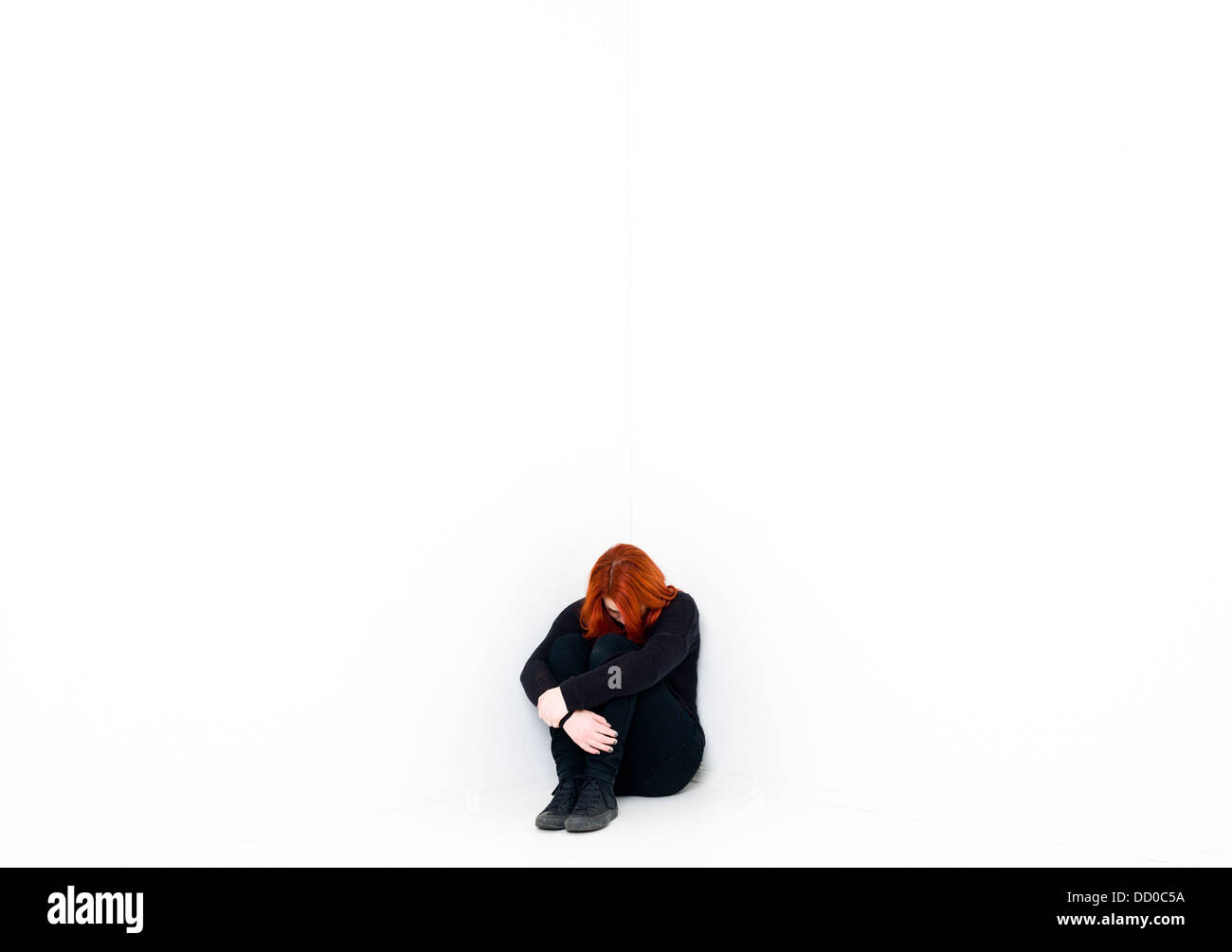 Sad woman standing wall Cut Out Stock Images & Pictures - Alamy