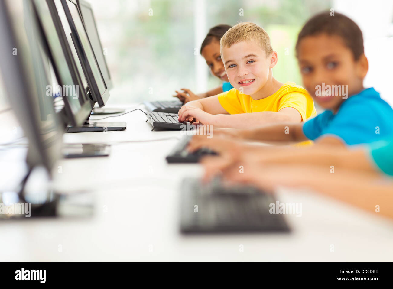 group of happy elementary school students in computer room Stock Photo ...