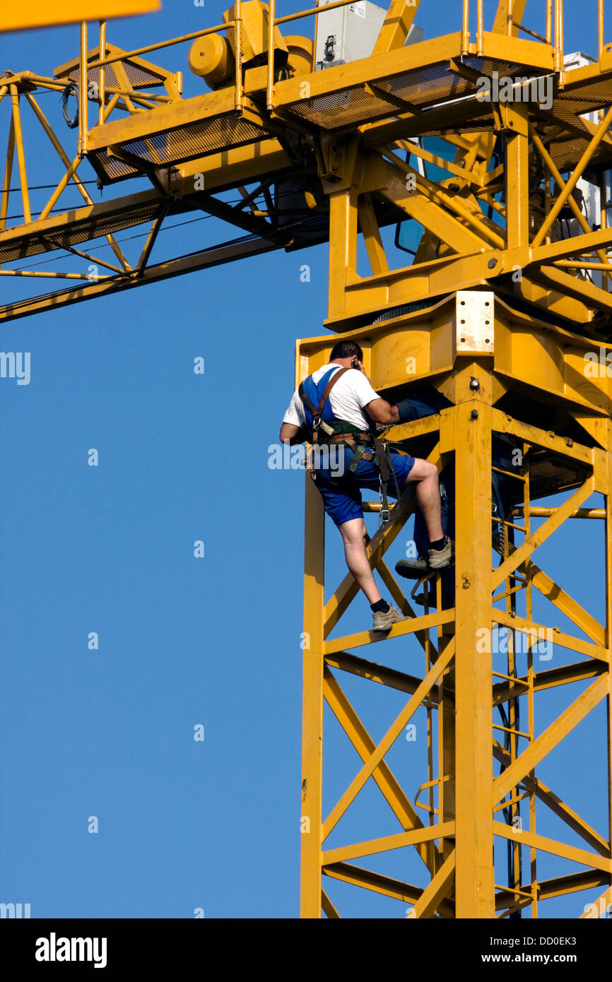 workman climbing crane tower during crane assembly Stock Photo - Alamy