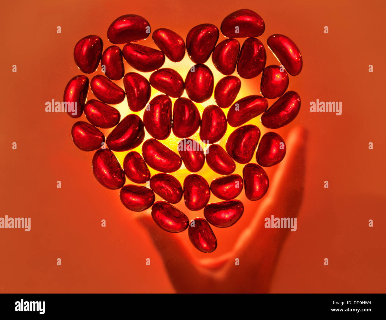 Hot red Heart in hand Stock Photo - Alamy