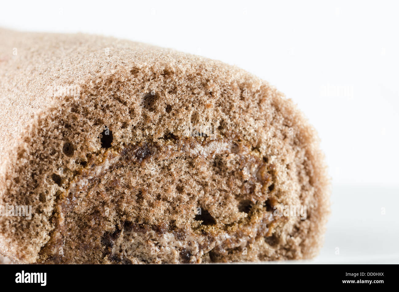 Roll chocolate cake and cream on white background Stock Photo - Alamy