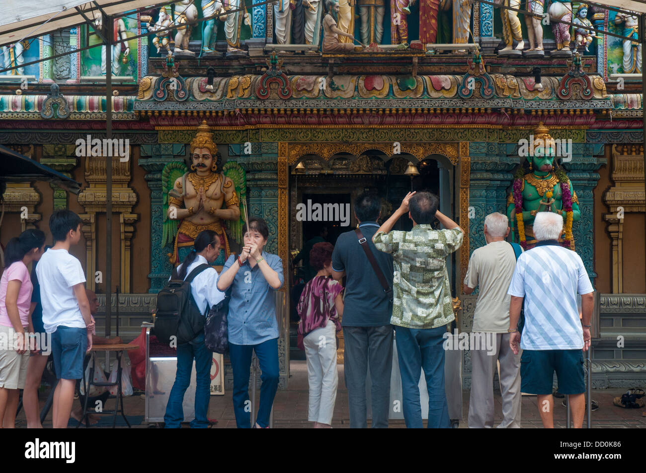 Chinese worshippers pray outside the Sri Krishnan Hindu Temple in ...