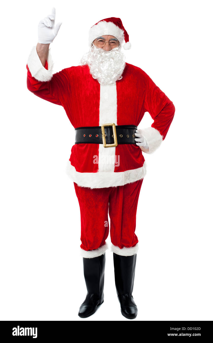 Bespectacled Santa pointing upwards. Copy space concept Stock Photo - Alamy